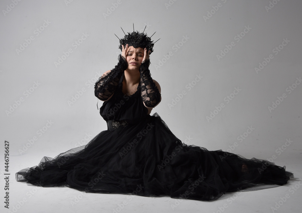 Full length portrait of young plus sized woman with short hair, wearing ...