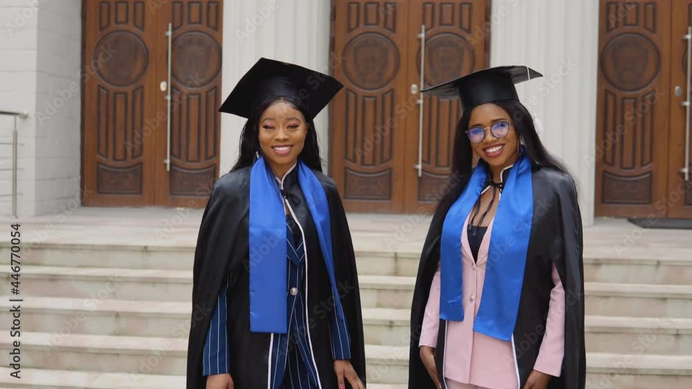 Two African-American women graduates in classic master's suits and ...