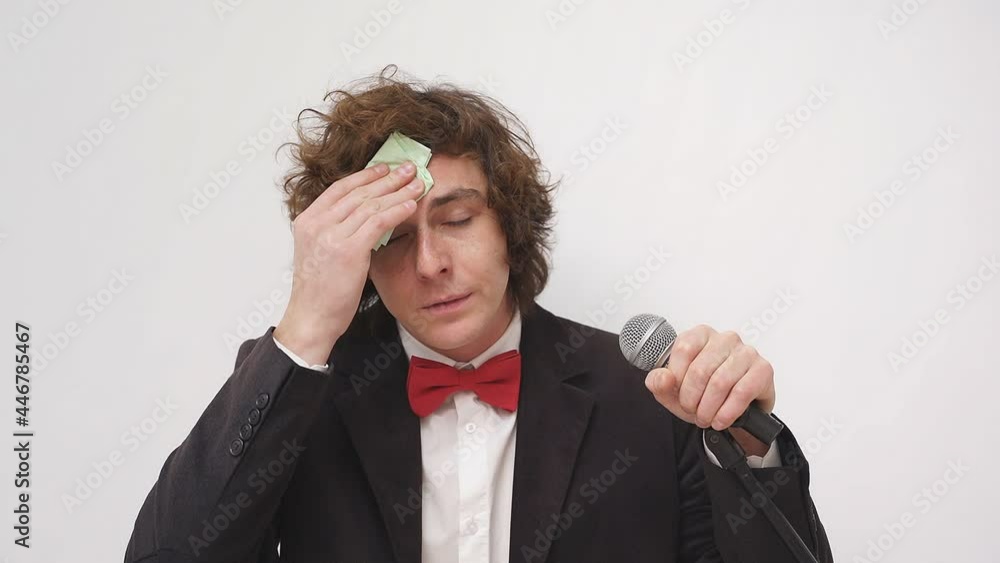 a nervous and shy Caucasian, a speaker with a microphone, a student is ...