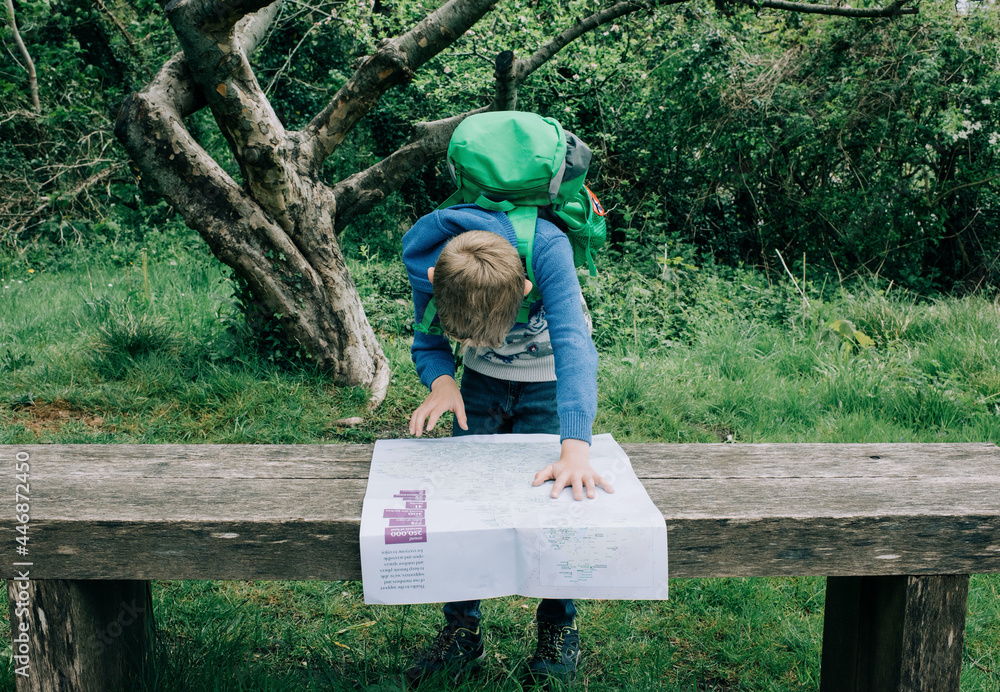 boy looking at a map of the UK whilst exploring the countryside Stock ...