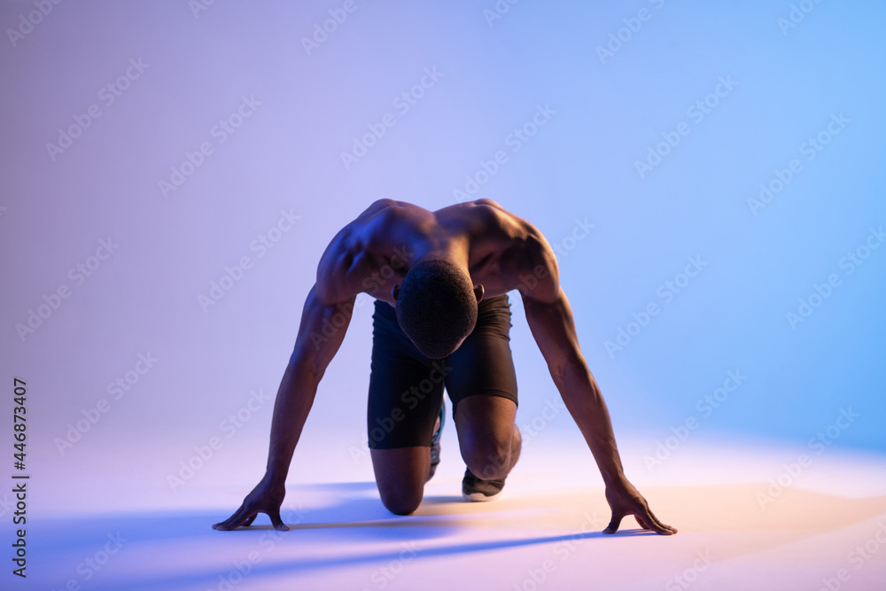 Black male runner standing in crouch start position Stock Photo | Adobe ...