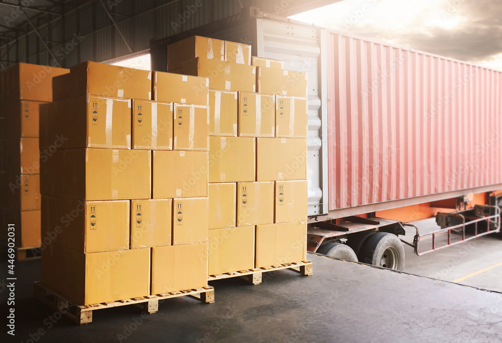 Stack of Package Boxes Load with Cargo Container. Trailer Truck Parked ...