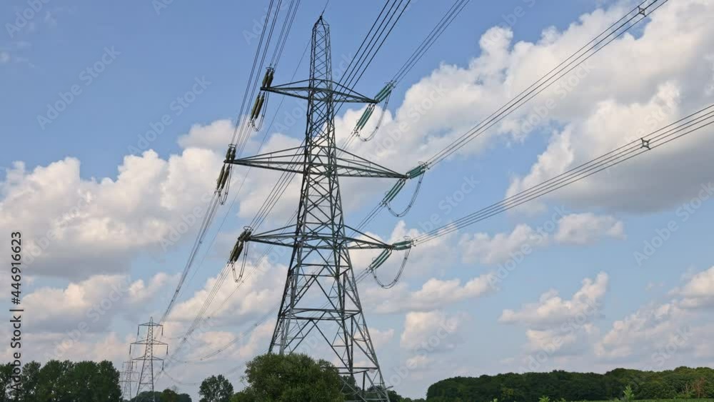 Electricity pylons in a field with clouds and blue sky time lapse. 4k ...