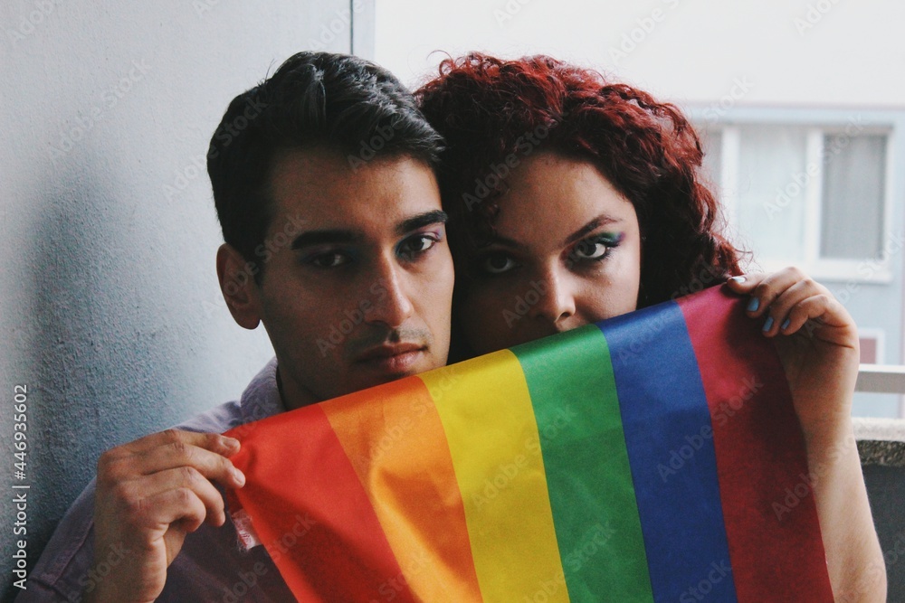 portait of two lgbtq queer friends holding rainbow pride flag Stock ...