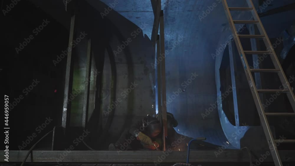 Inside Industrial Production Site. Male Operator is Welding a Metal ...