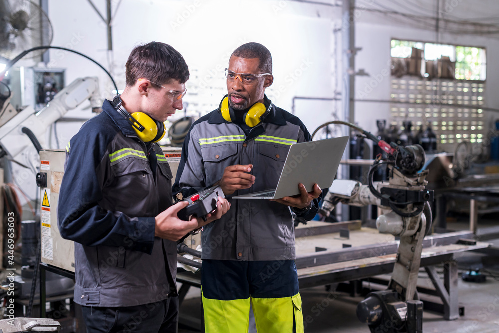 Robotics control engineers setting and maintain spare parts of ...