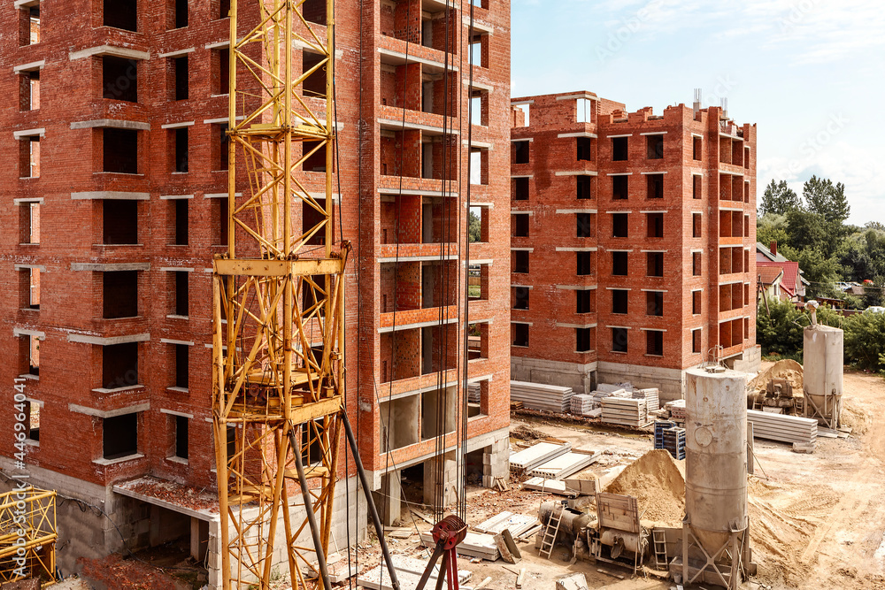 Construction site with a tower crane and a concrete unit. Multi-storey ...