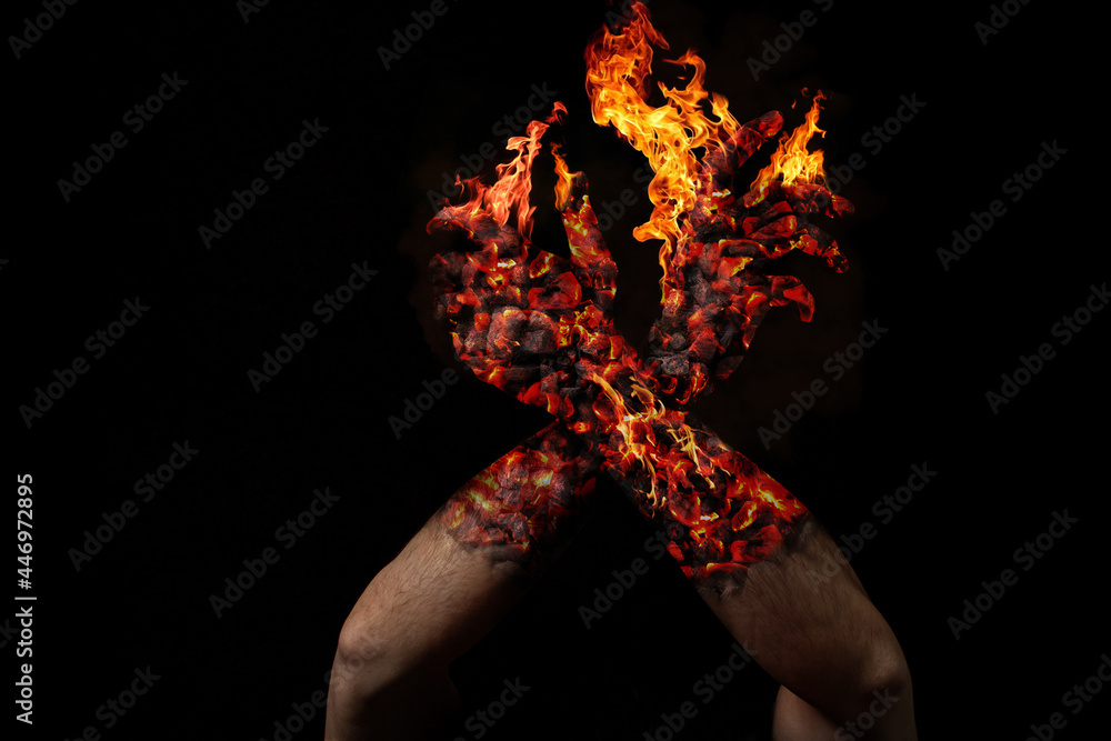 Burning hands on a black background. Combustion of the human term ...