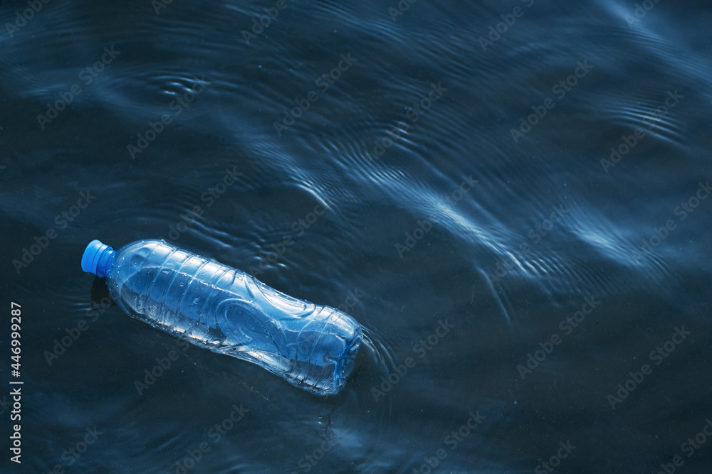 A plastic bottle floats in the river. Environmental problem of ...