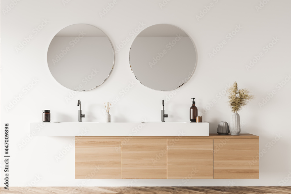 Light beige bathroom wall with original vanity and round mirrors Stock ...