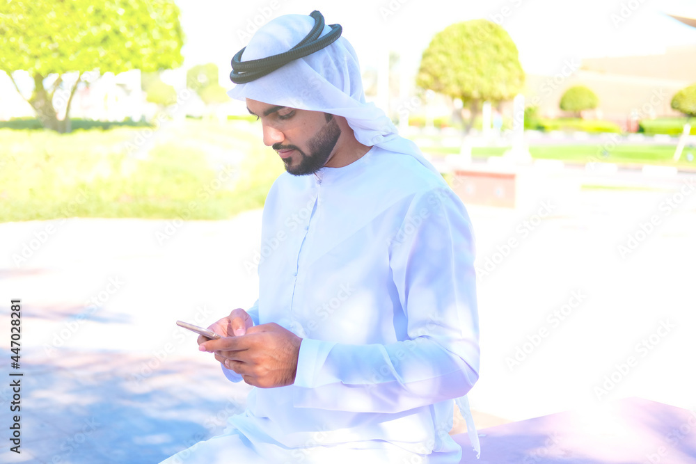 Arab man waiting car service through smart moble phone app. Arabic man ...