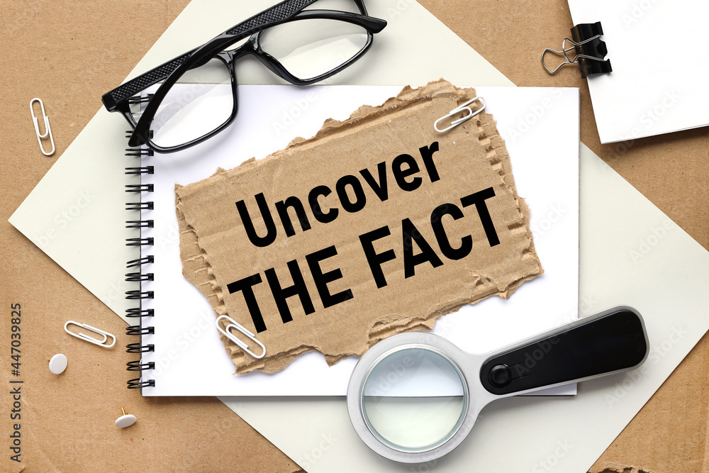 Uncover the Facts. text on torn cardboard on craft background Stock ...