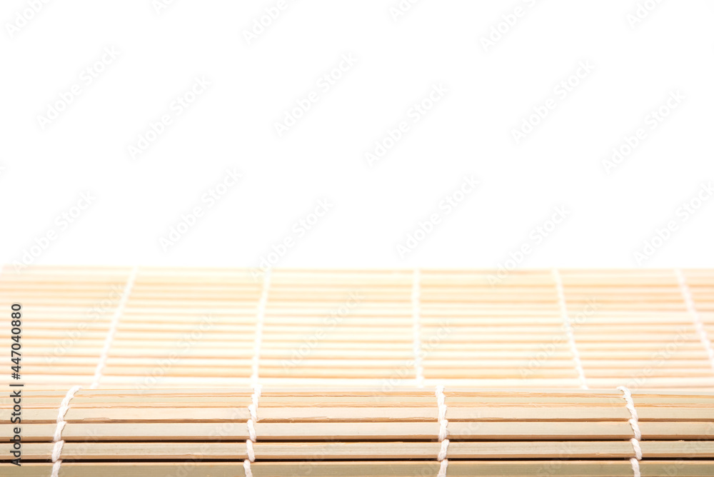 Partly rolled up shushi bamboo mat isolated on white background ...