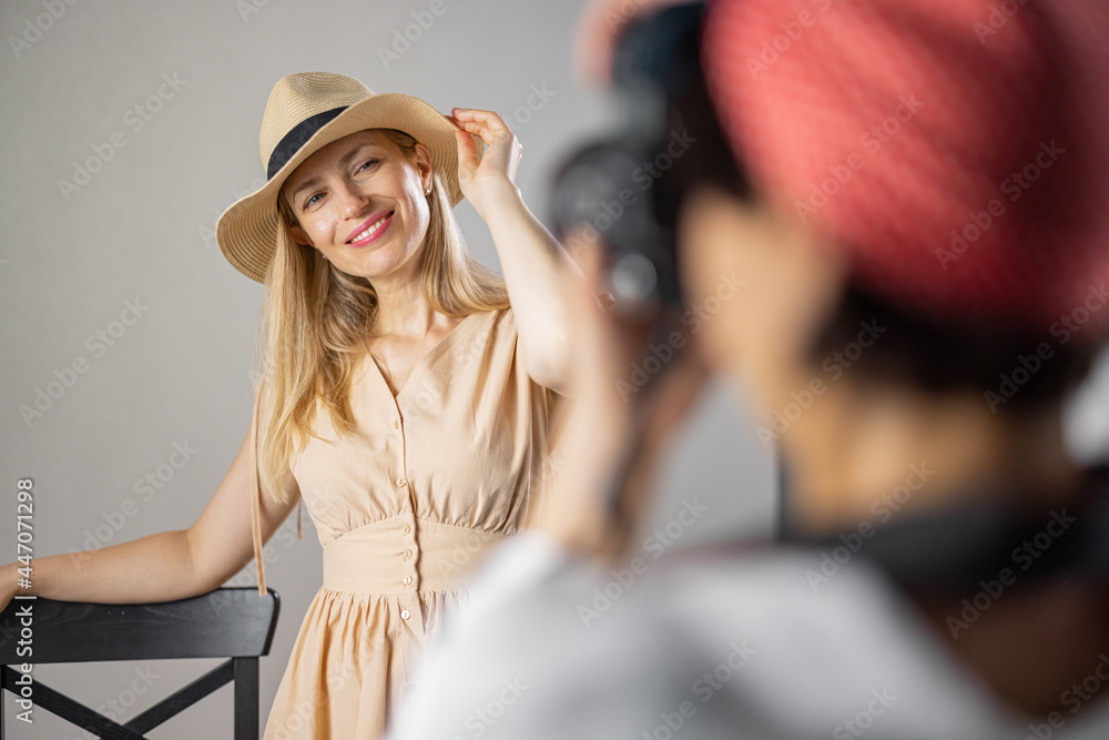 Attractive woman with blond hair posing and smiling during professional ...
