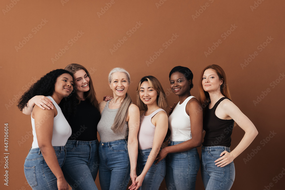 Multi Ethnic Group Of Women Of Different Ages Posing Against Brown