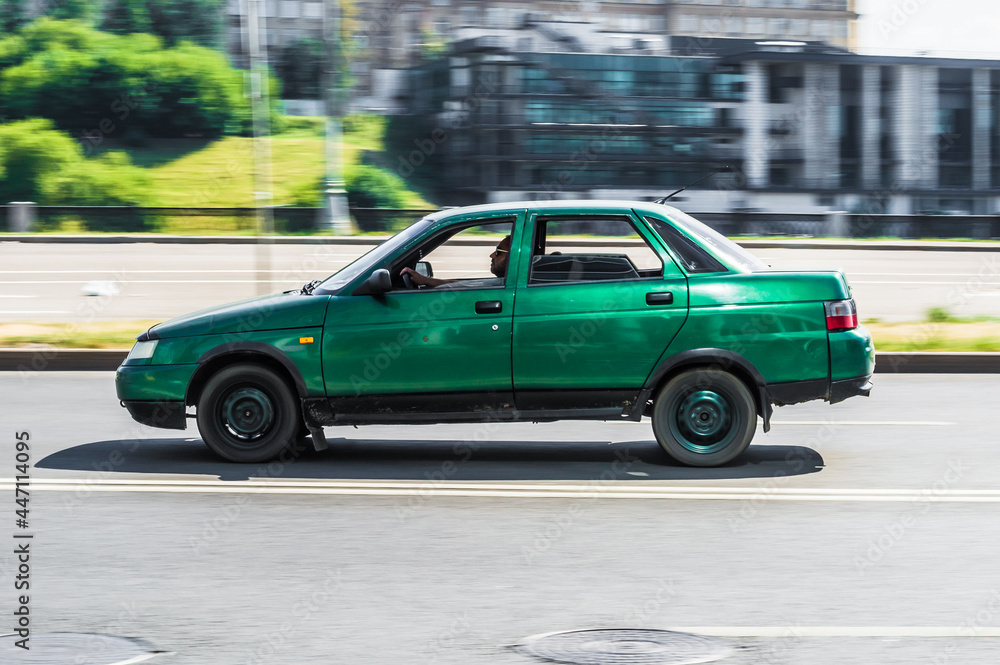 Old green Lada 2110 in motion. Speeding in city road concept. Obsolete ...
