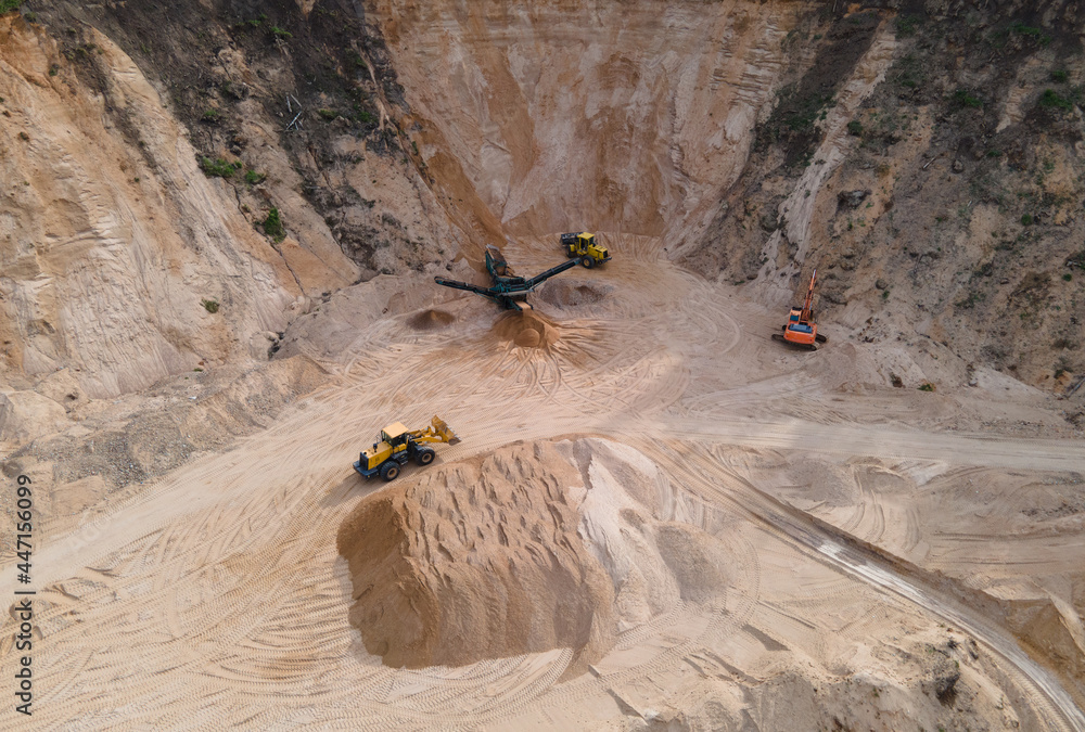 Arial view of the open pit mine. Front end loader loading gravel into ...