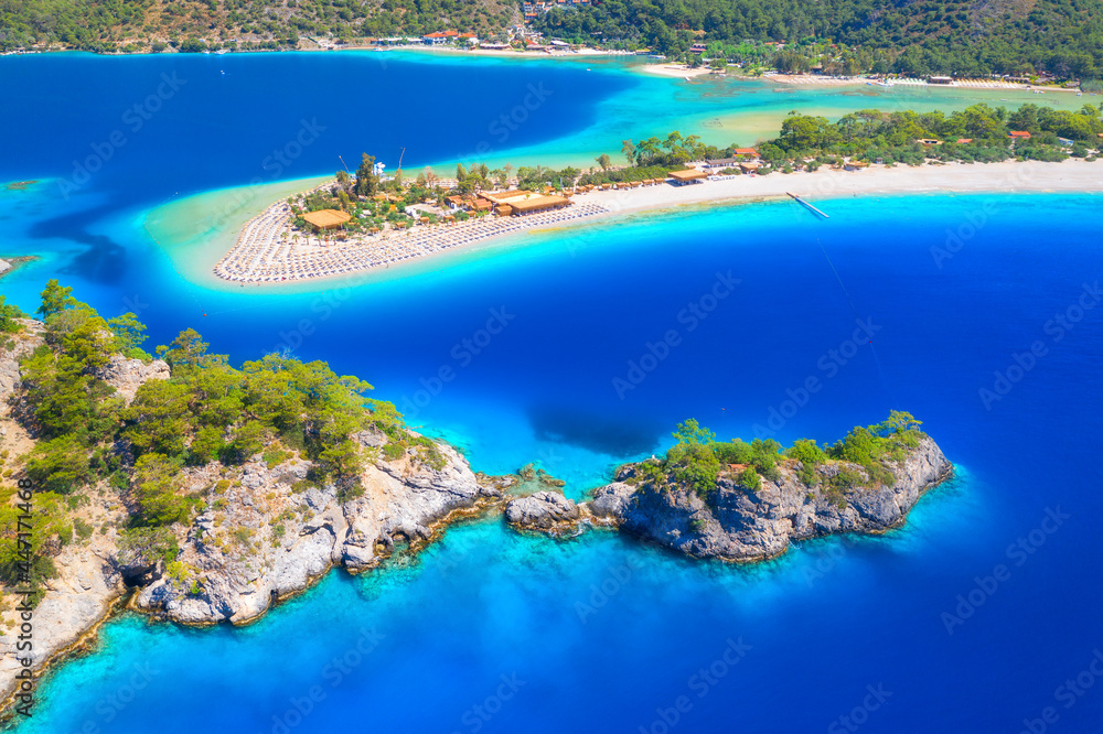 Aerial view of sea bay, rock, sandy beach, trees, mountain at sunny day ...