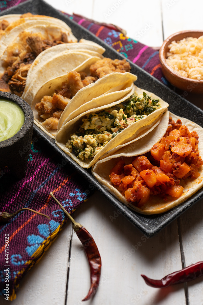 Different types of tacos also called guisados on a white background ...