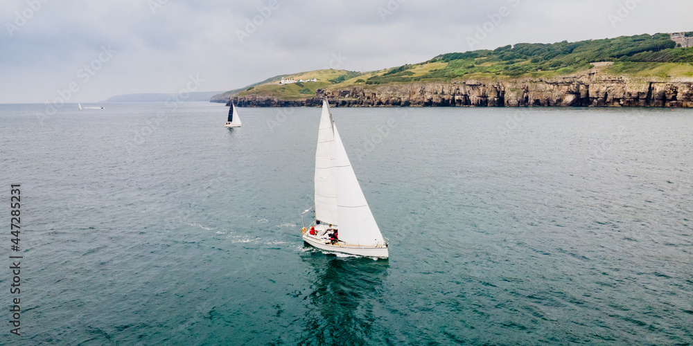 Sail boat sailing along the Jurassic Coast in Devon, South West England ...