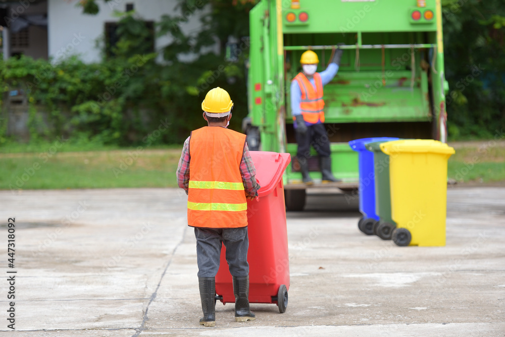garbage collector Two garbagemen working together on emptying dustbins ...