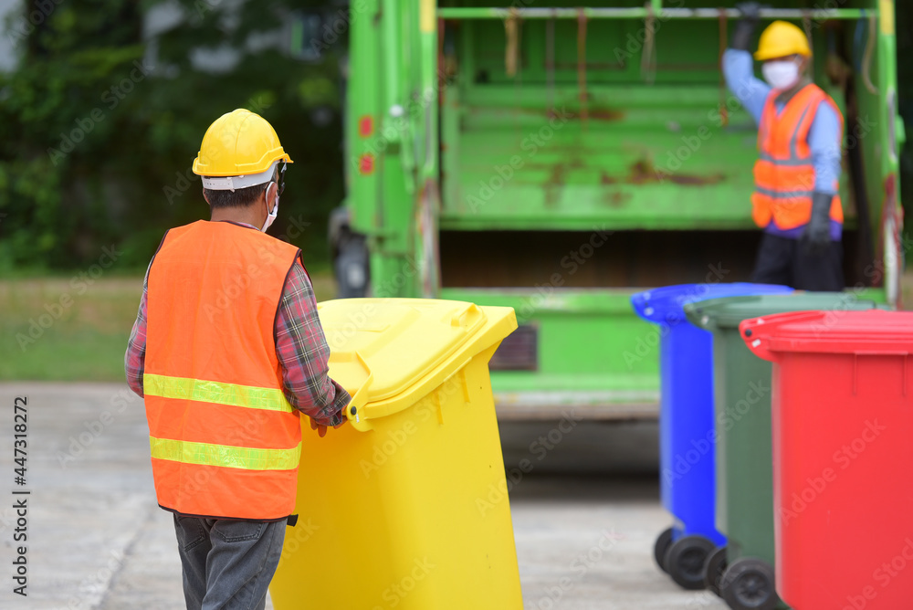 garbage collector Two garbagemen working together on emptying dustbins ...