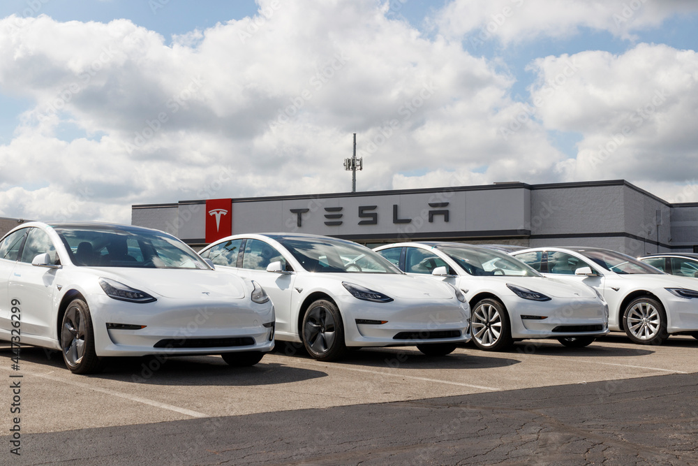 Tesla electric vehicles awaiting preparation for sale. Tesla EV Model 3 ...