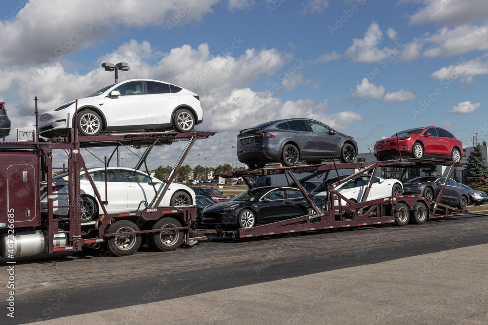 Tesla electric vehicles awaiting preparation for sale. Tesla EV Model 3 ...