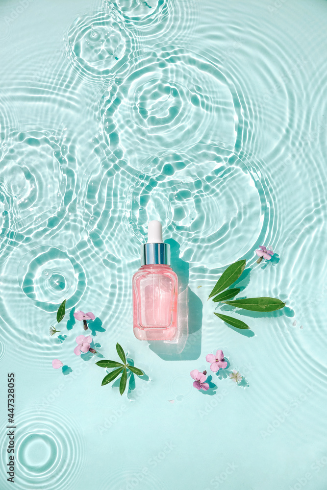 Moisturizing cosmetic products on water with drops. Serum glass bottle ...