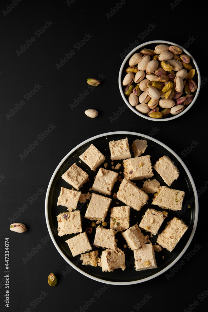 Organic halva with pistachios on black background. Traditional middle ...