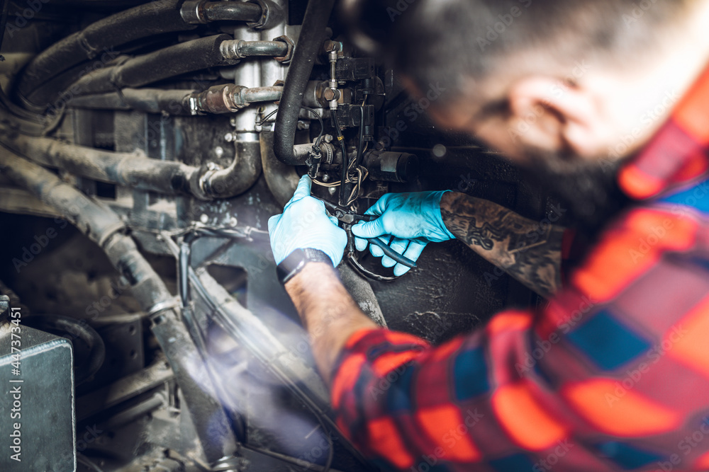 Professional bus mechanic working in vehicle repair service. Stock ...