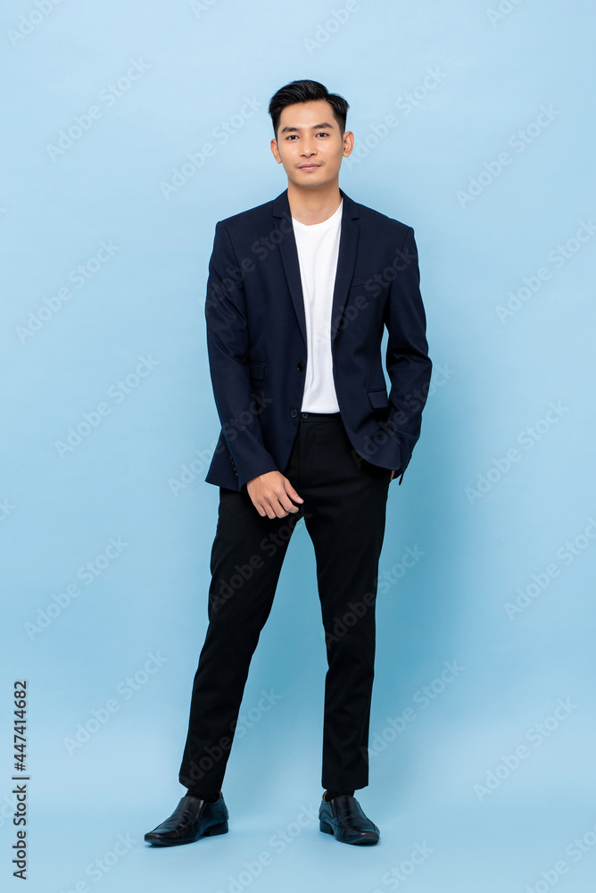 Full length portrait of smiling young handsome Asian man in semi formal ...