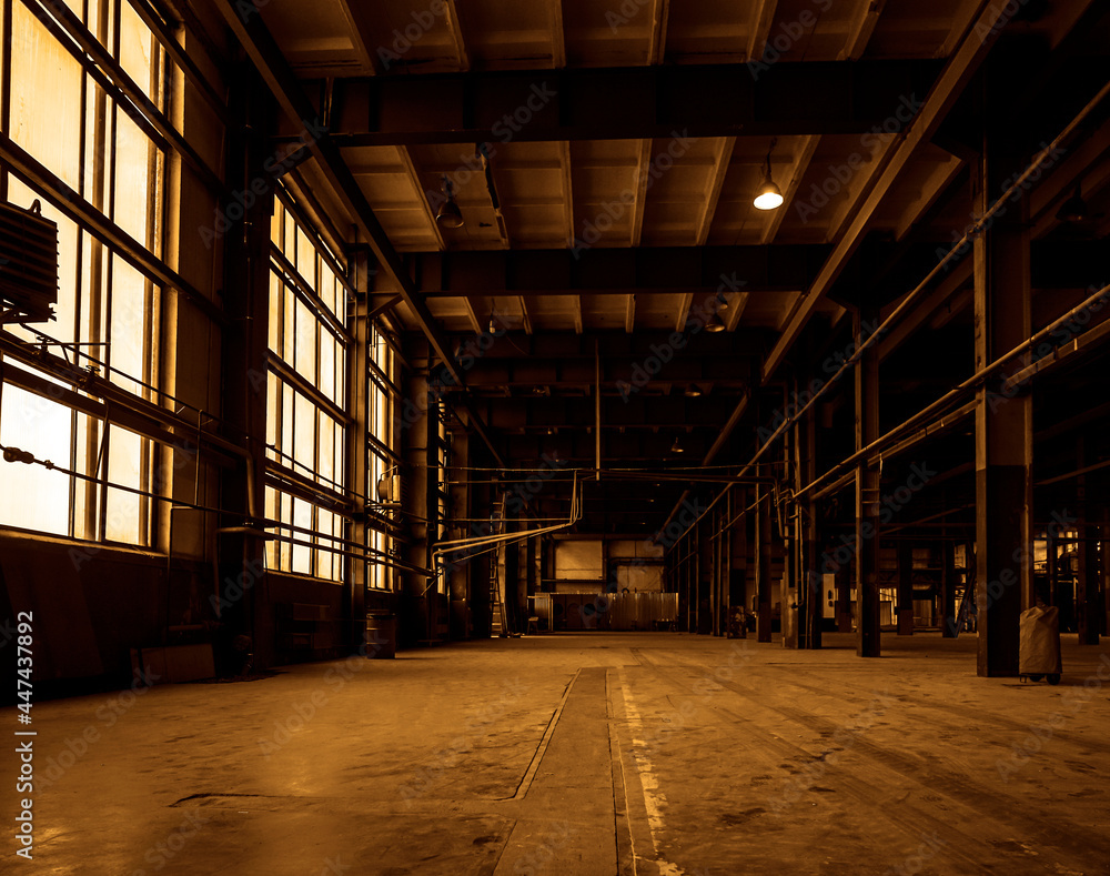 Interior of old abandoned factory hallway with big windows. empty steel ...