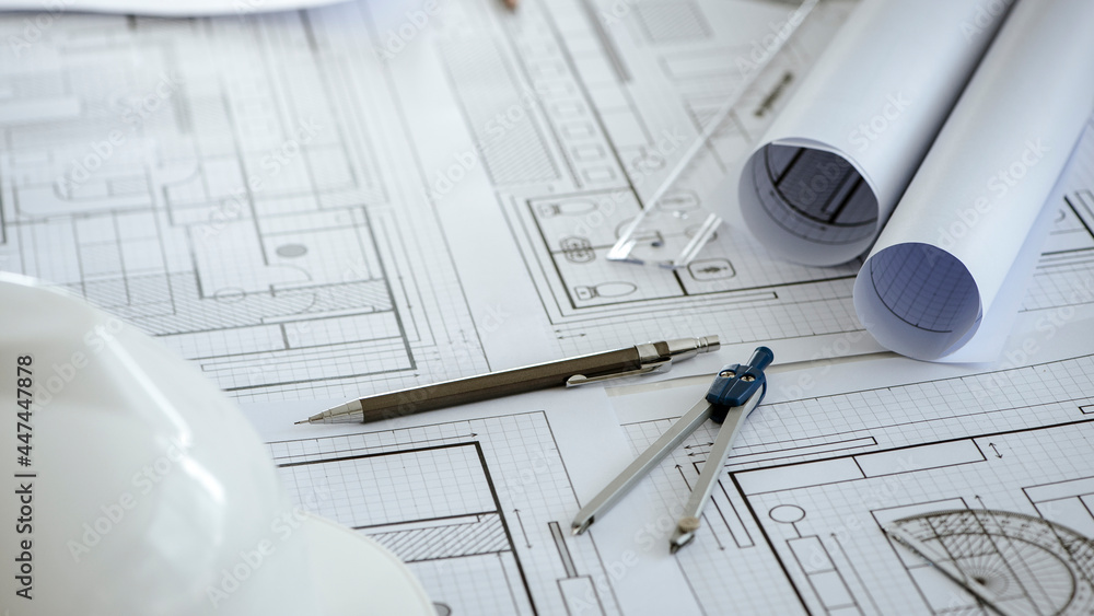 Yellow hard safety helmet hat and architectural blueprints and ...