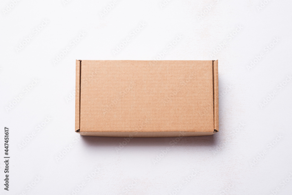 Cardboard, carton mailer box, case, top view on white wooden background ...