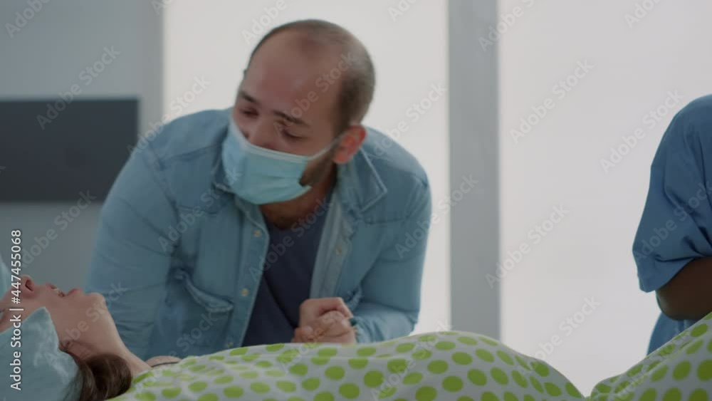 Caucasian patient in agony delivering child in hospital ward at medical ...