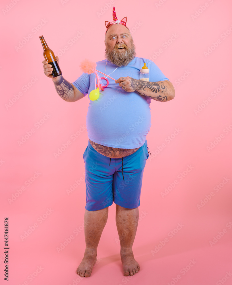 Fat happy man acts like a happy baby but drinks beer Stock Photo ...