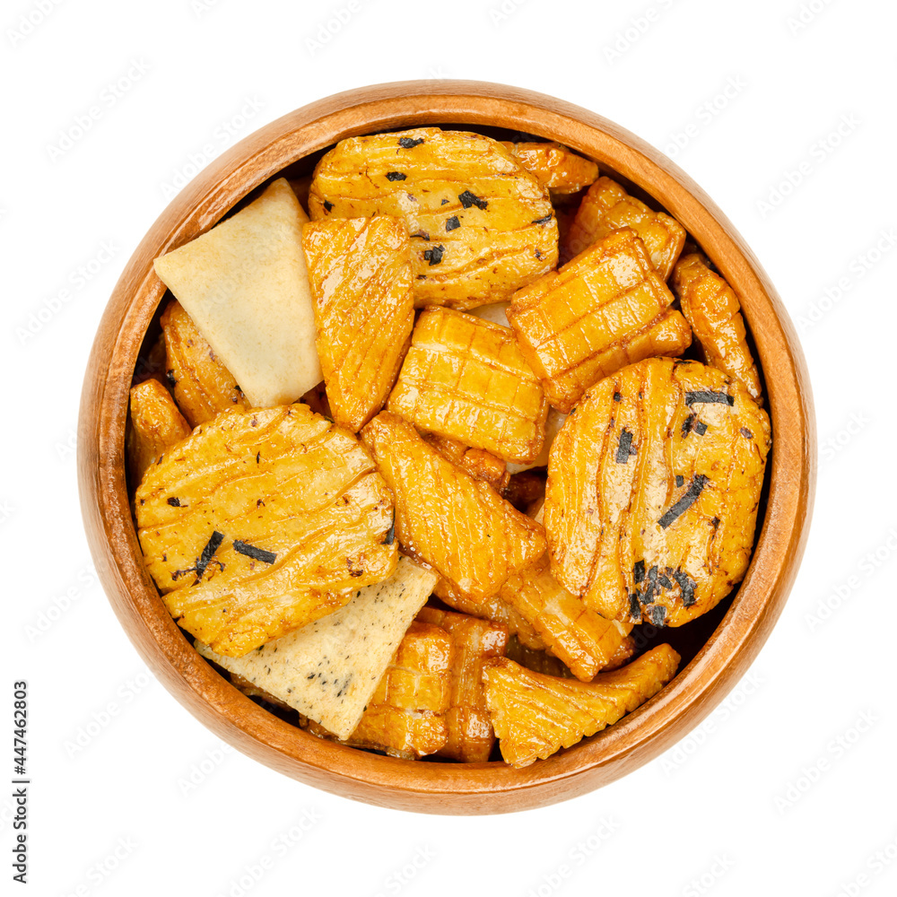 Senbei, Japanese rice crackers, in a wooden bowl. Also sembei, crispy ...