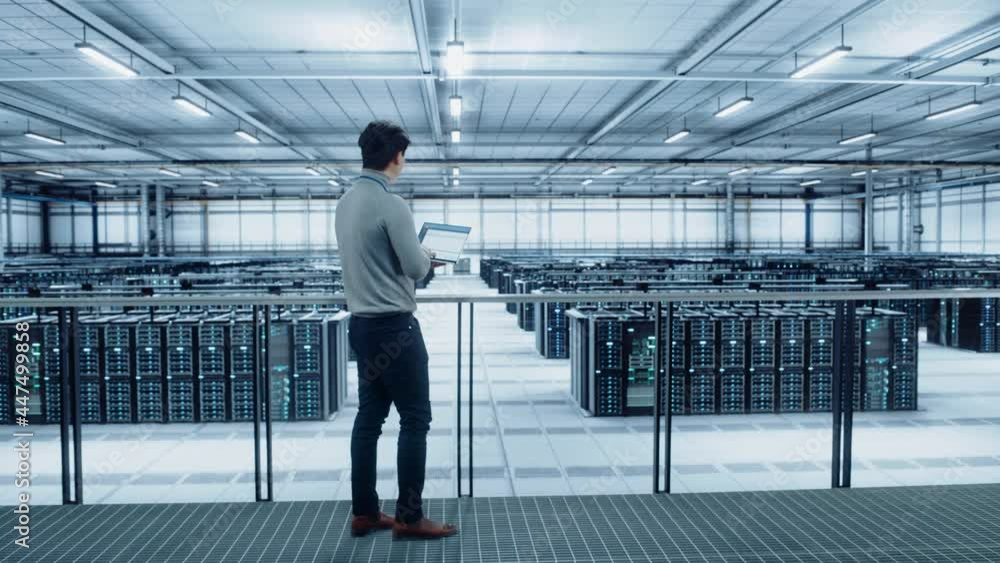 Data Center Engineer Using Laptop Computer. Server Farm Cloud Computing ...