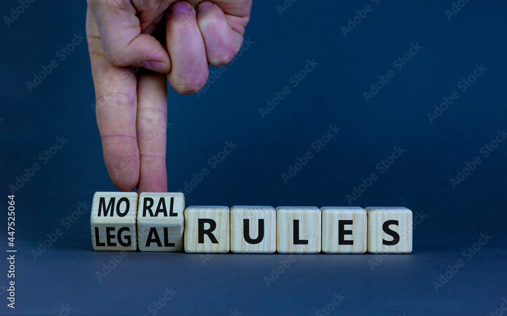 Legal or moral rules symbol. Businessman turns wooden cubes and changes ...