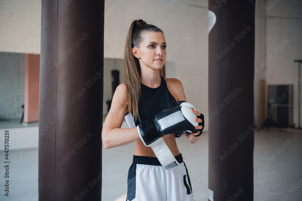Female fighter trains her punches, training day in the boxing gym, the ...