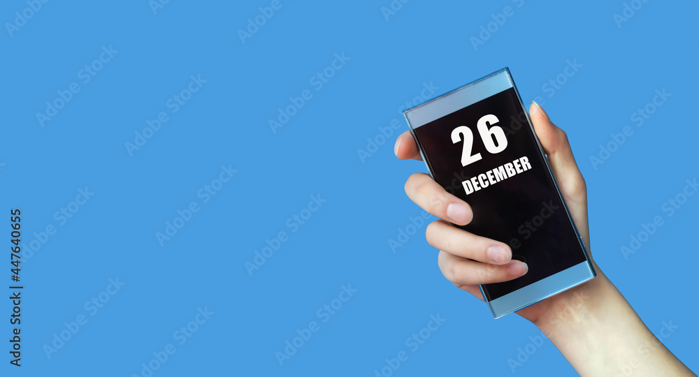 december 26. 26th day of the month, calendar date.Woman's hand holds ...