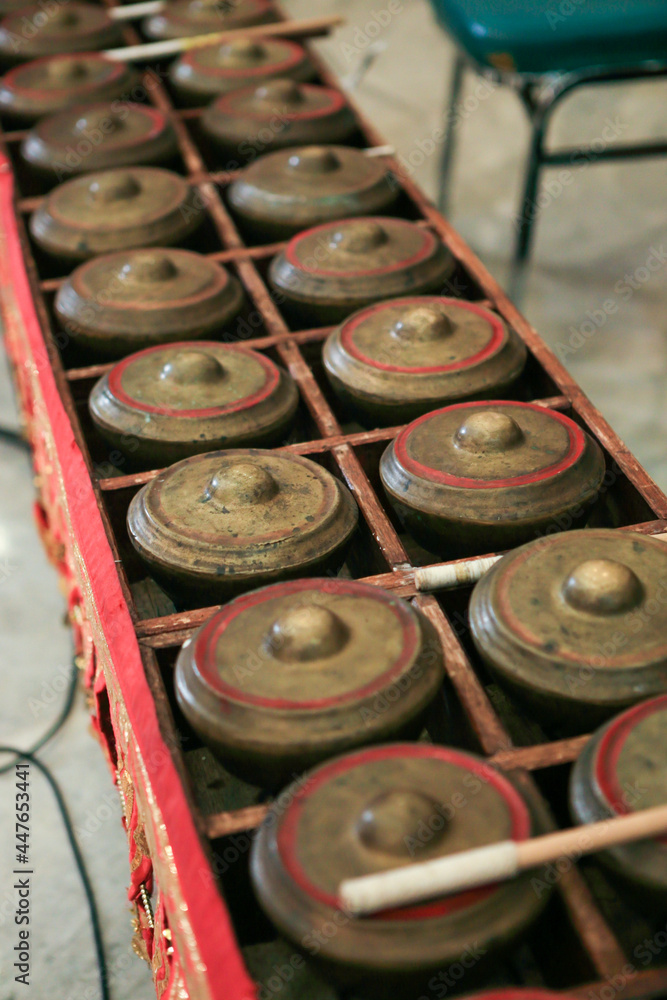 Set of small brass gongs called talempong, a traditional music ...