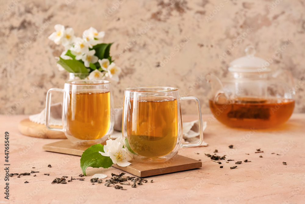 Cups of aromatic jasmine tea on color background Stock Photo | Adobe Stock