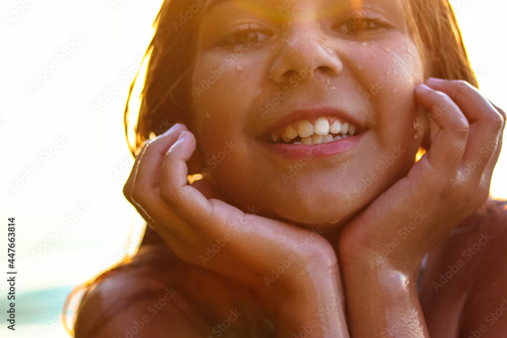 Happy teenage girl smiling broadly looking at a camera. A 10-12 year ...