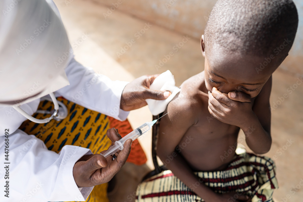 Fearful little black toddler during routine preschool vaccination in a ...