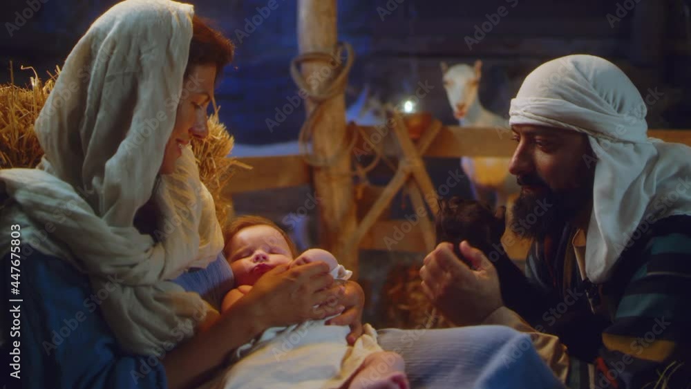 Joseph with lamb and Mary with baby Jesus in stable nativity scene ...