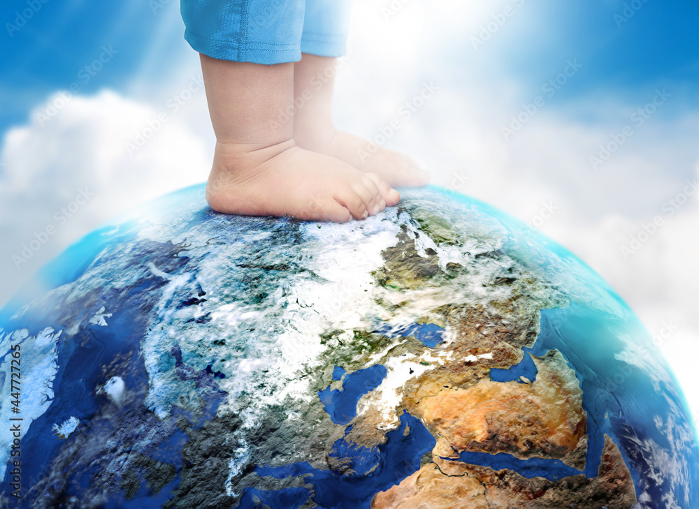 Child standing on planet earth. Protect our world for the next ...