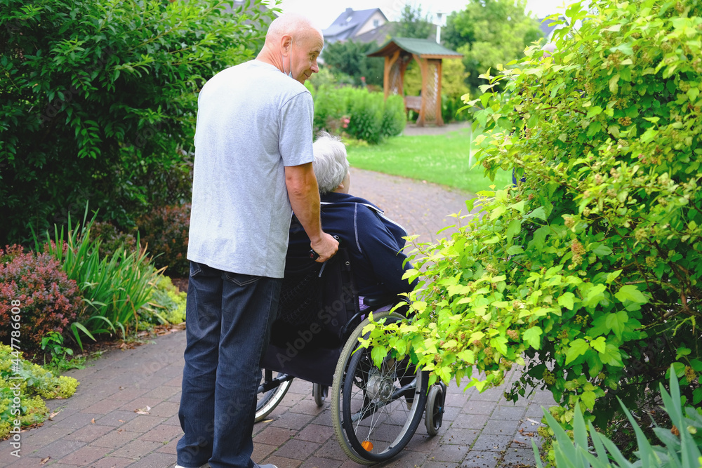 male nurse, relative in park is driving elderly woman 70-75 years ...