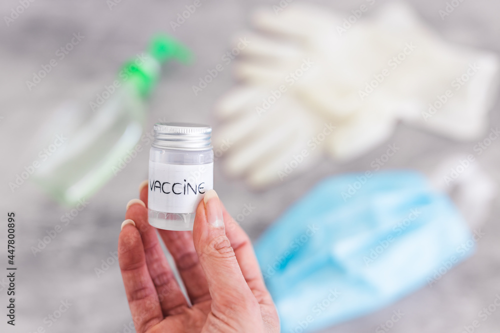 covid-19 vaccine race, hand holding vaccine ampooule with disposable ...